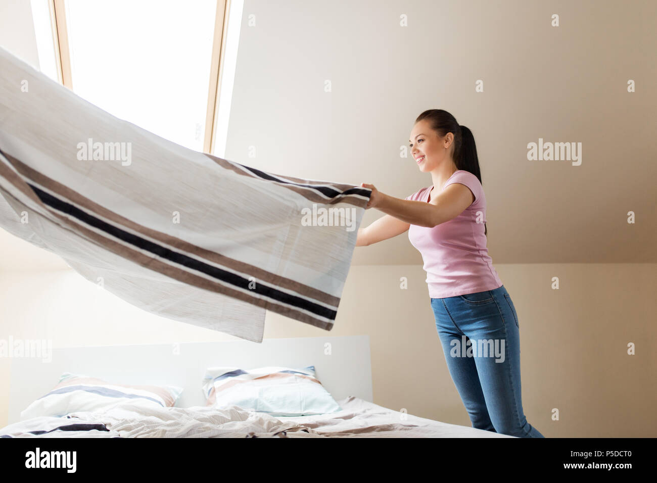 happy woman or housewife making bed at home Stock Photo - Alamy