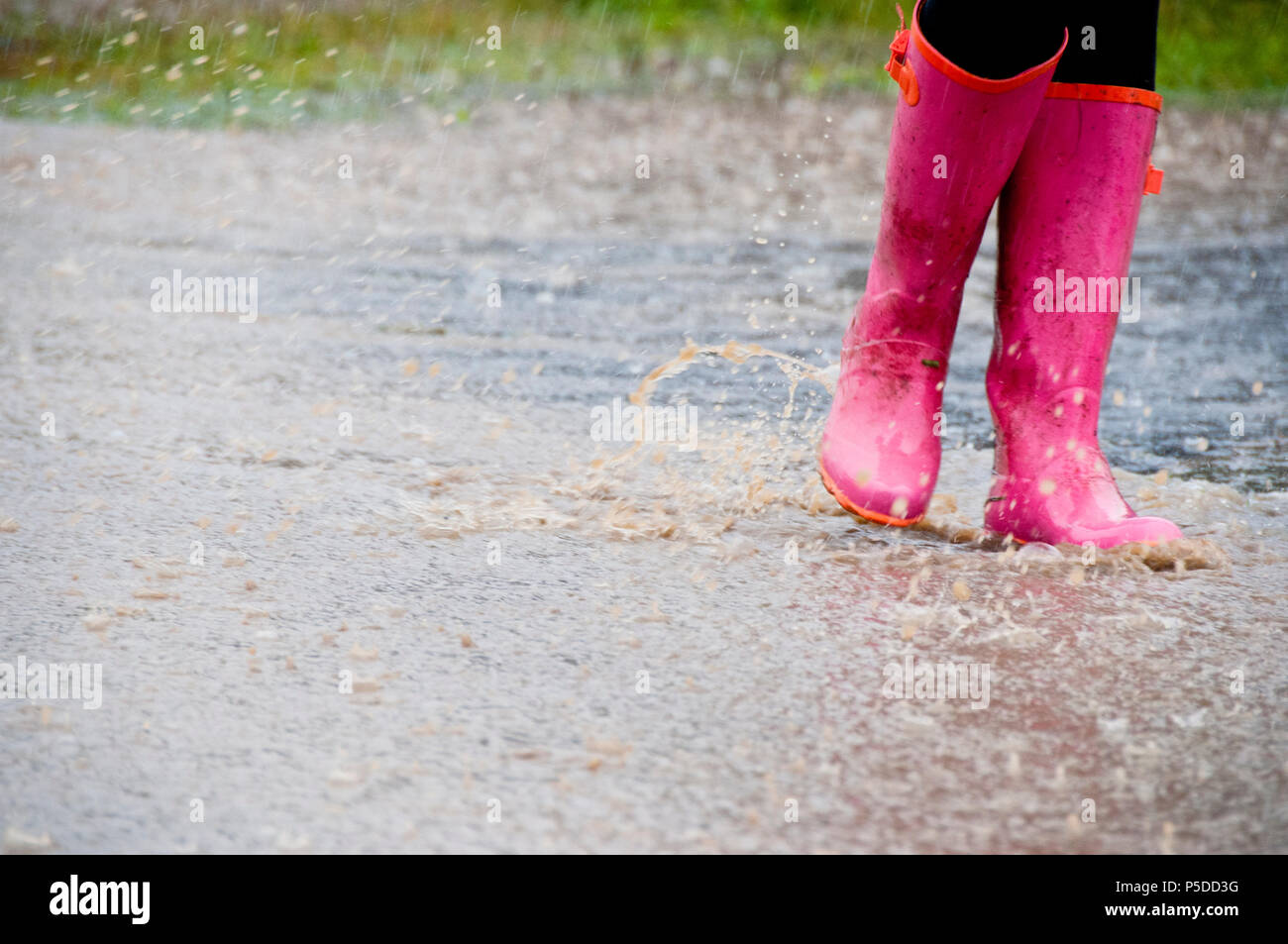 Feet running through puddle hi-res stock photography and images - Alamy