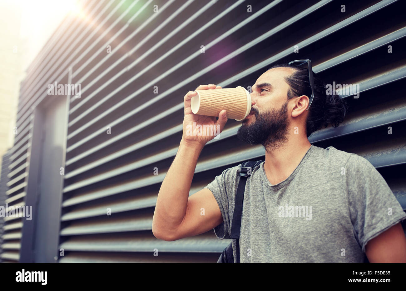 man drinking coffee from paper cup on street Stock Photo - Alamy