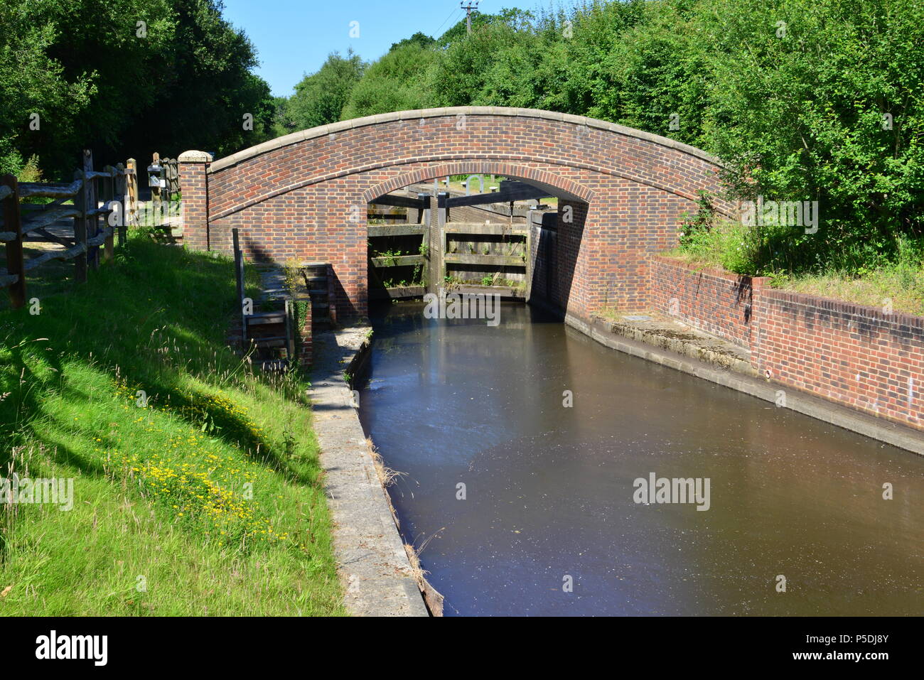 Bridge crossing the Wey and Arun canal just before a lock Stock Photo ...