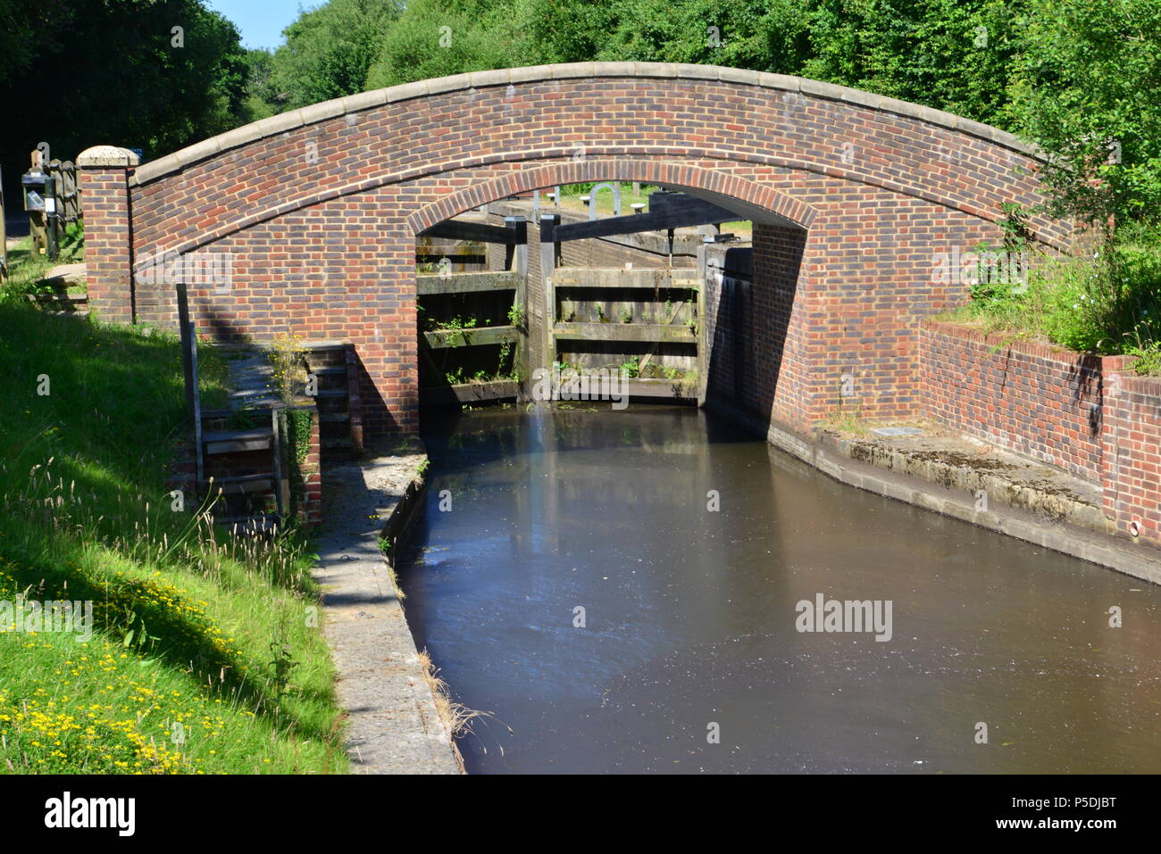 Bridge crossing the Wey and Arun canal just before a lock Stock Photo ...