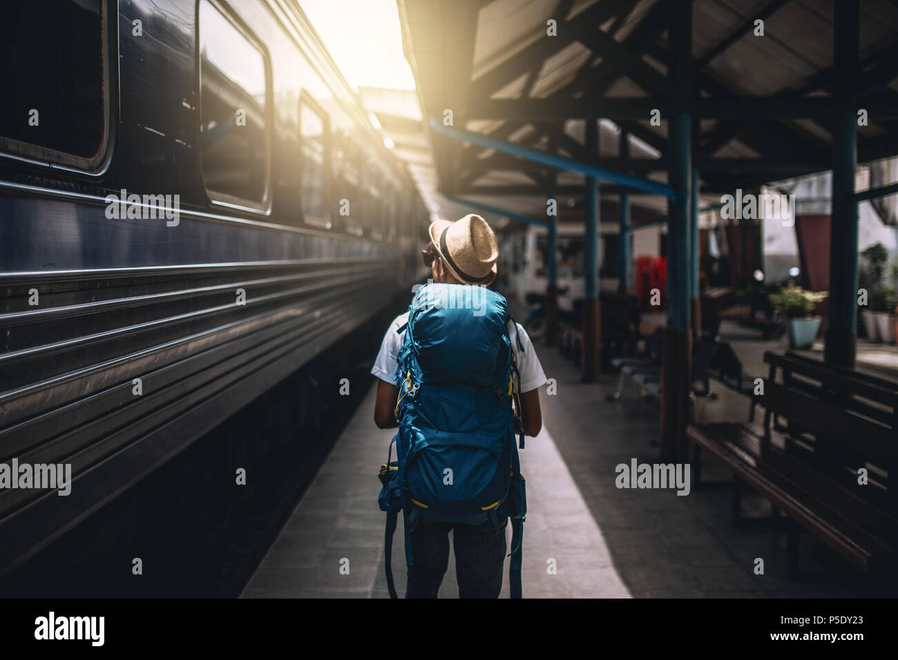 Traveler are backpacking and walking alone at train station Stock Photo ...