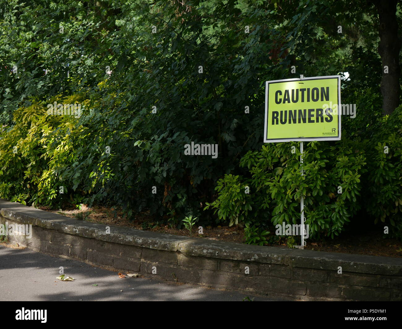 Caution Runners sign at Park Run in Bishops Park Fulham Stock Photo - Alamy