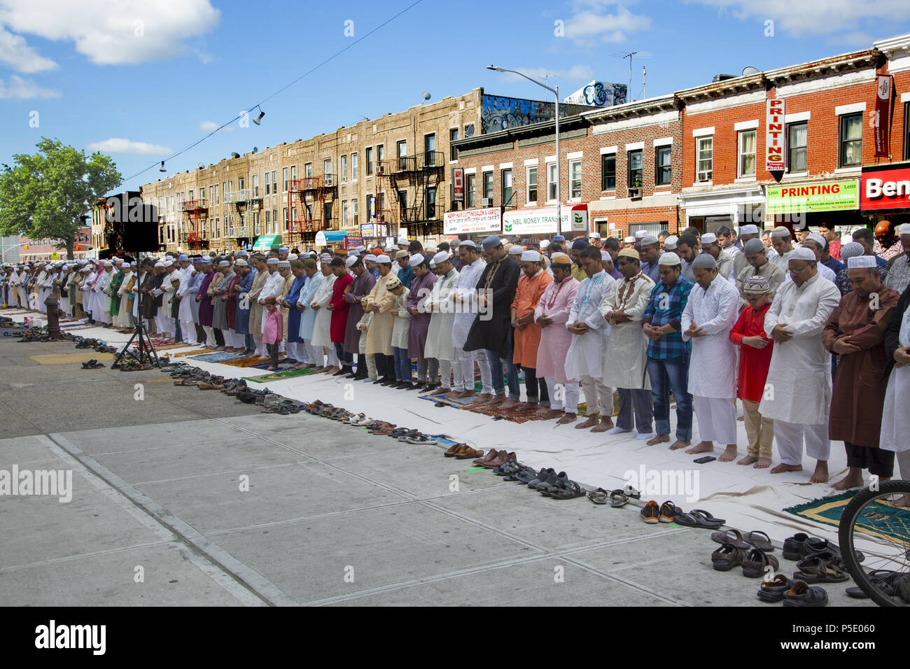Muslim men pray on Eid on McDonald Ave in Brooklyn NY in the "Little ...