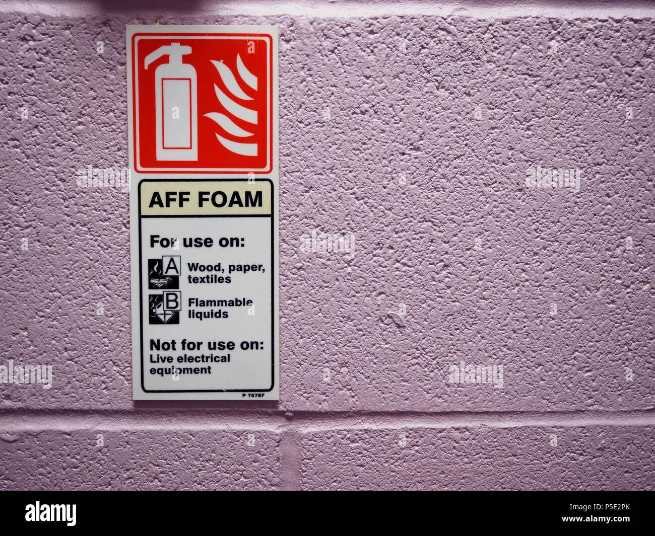 aff foam spray Fire extinguisher sign on a purple brick wall Stock ...