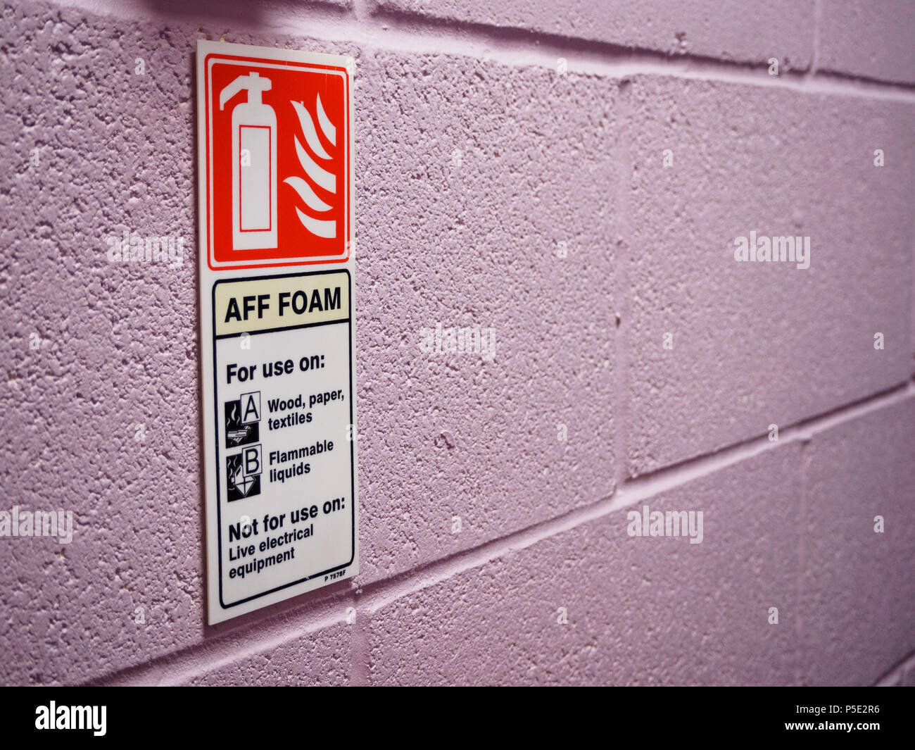 aff foam spray Fire extinguisher sign on a purple brick wall Stock ...