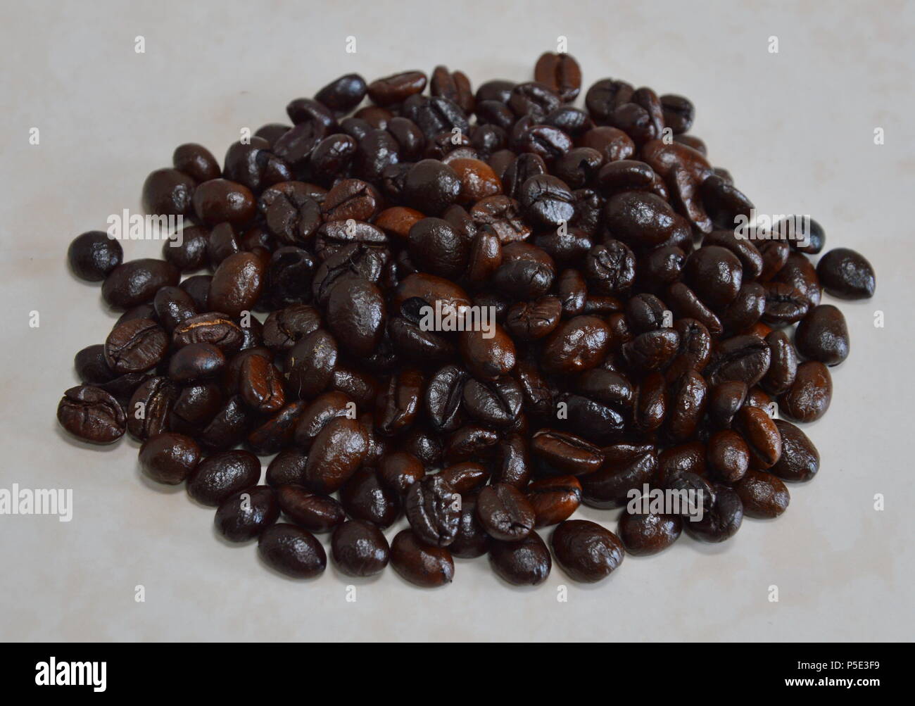 coffee seed on tile background Stock Photo - Alamy