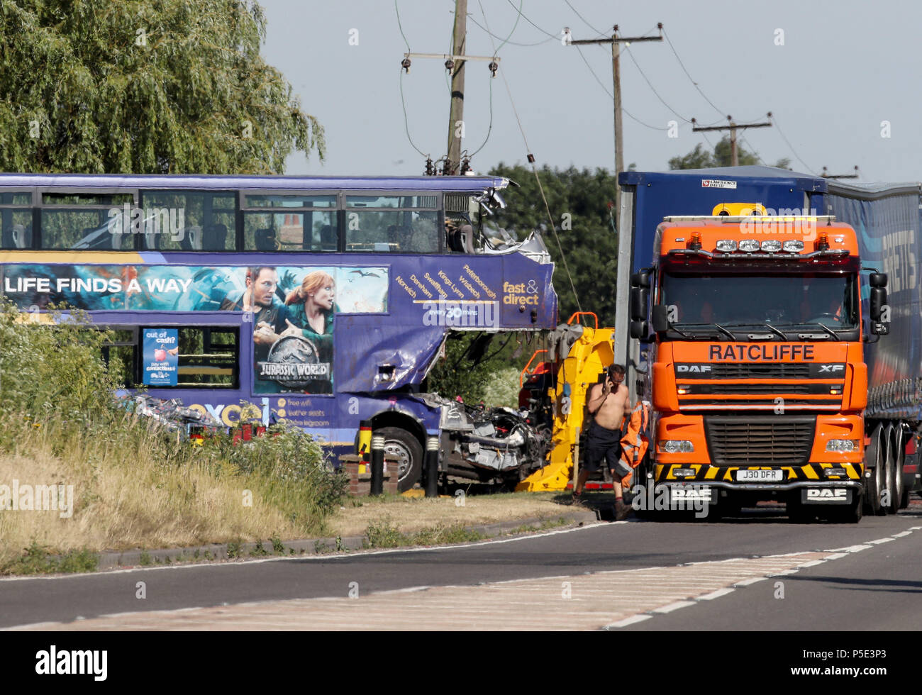 The wreckage of a double-decker bus is removed from the scene on the ...