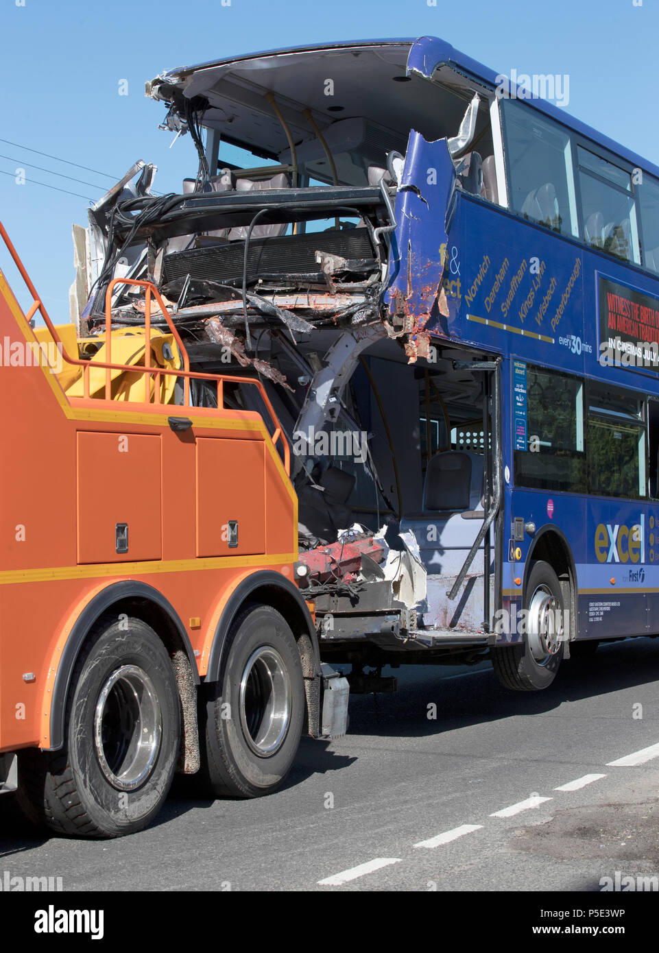 The wreckage of a double-decker bus is removed from the scene on the ...