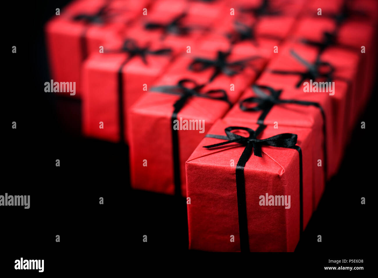 many red gift boxes on black background Stock Photo - Alamy