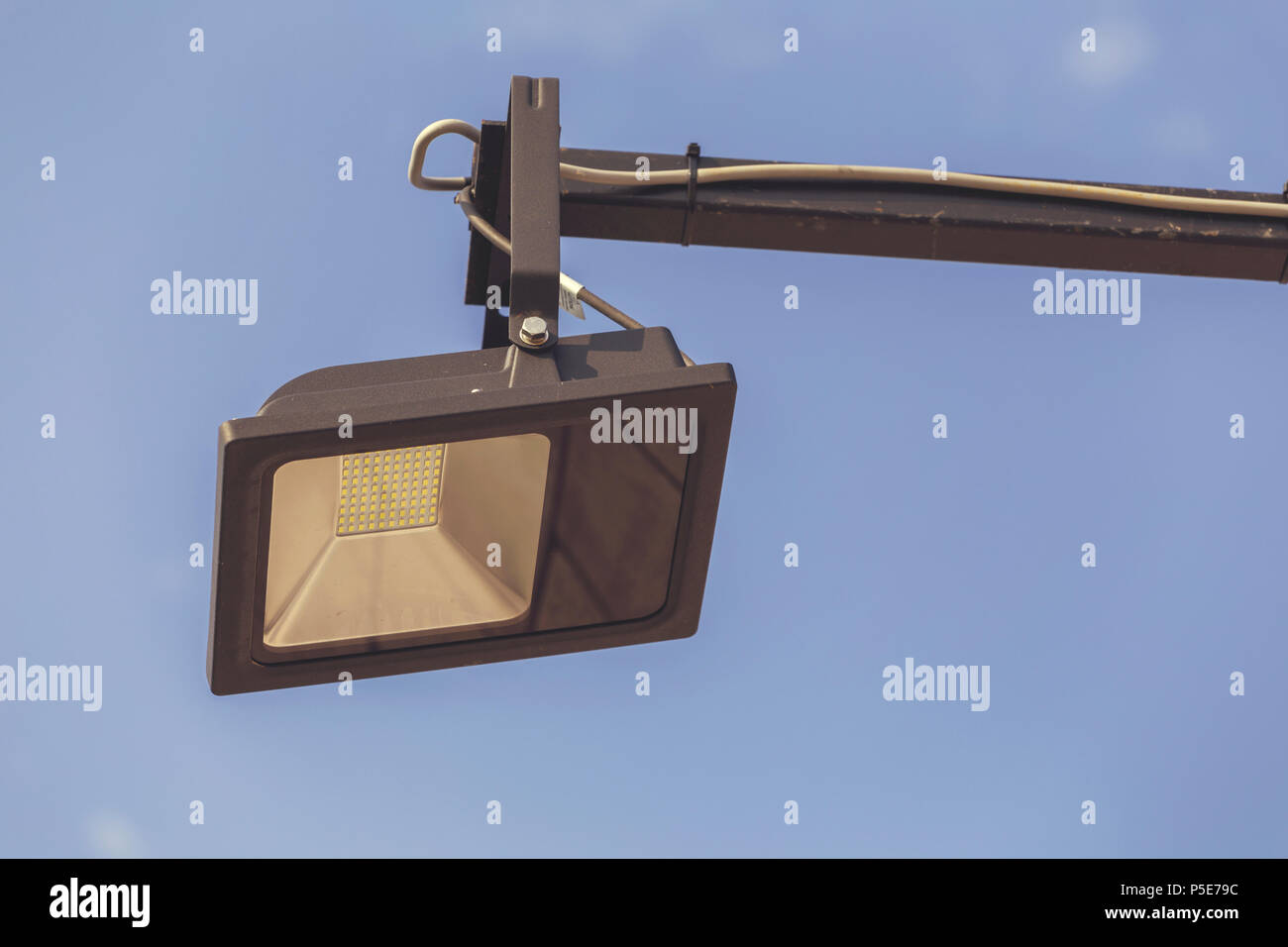 Outdoor single led street light with cable on sky background. Selective ...