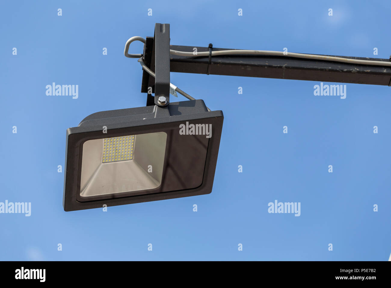 Outdoor single led street light with cable on sky background. Selective ...