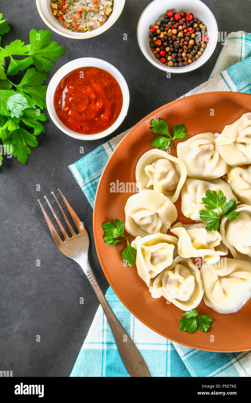 Homemade ready dumplings on a gray concrete table Stock Photo - Alamy