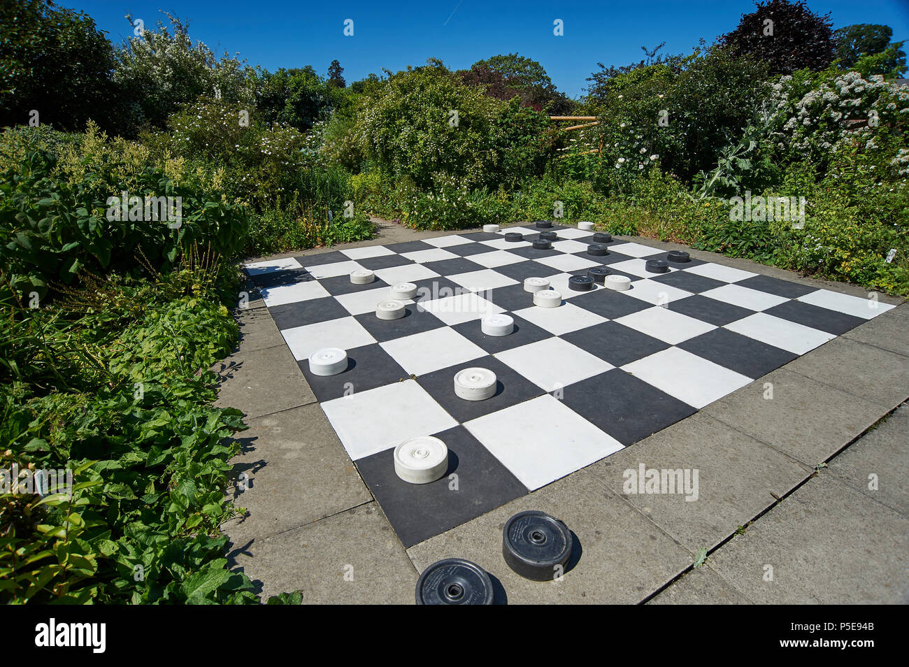 Outdoor giant draughts or checkers game in formal flower garden, Burton ...