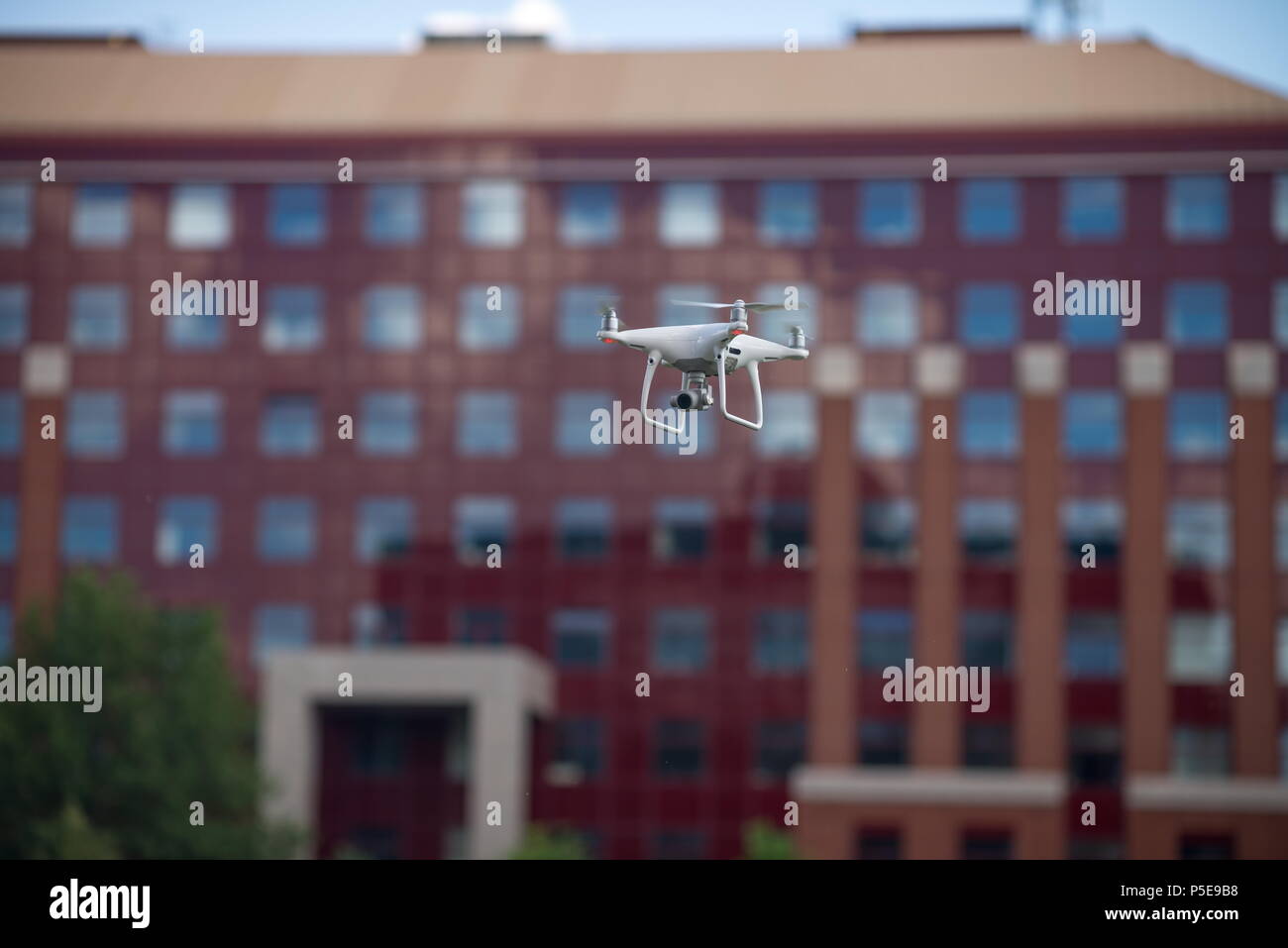 White drone in front of a building Stock Photo - Alamy