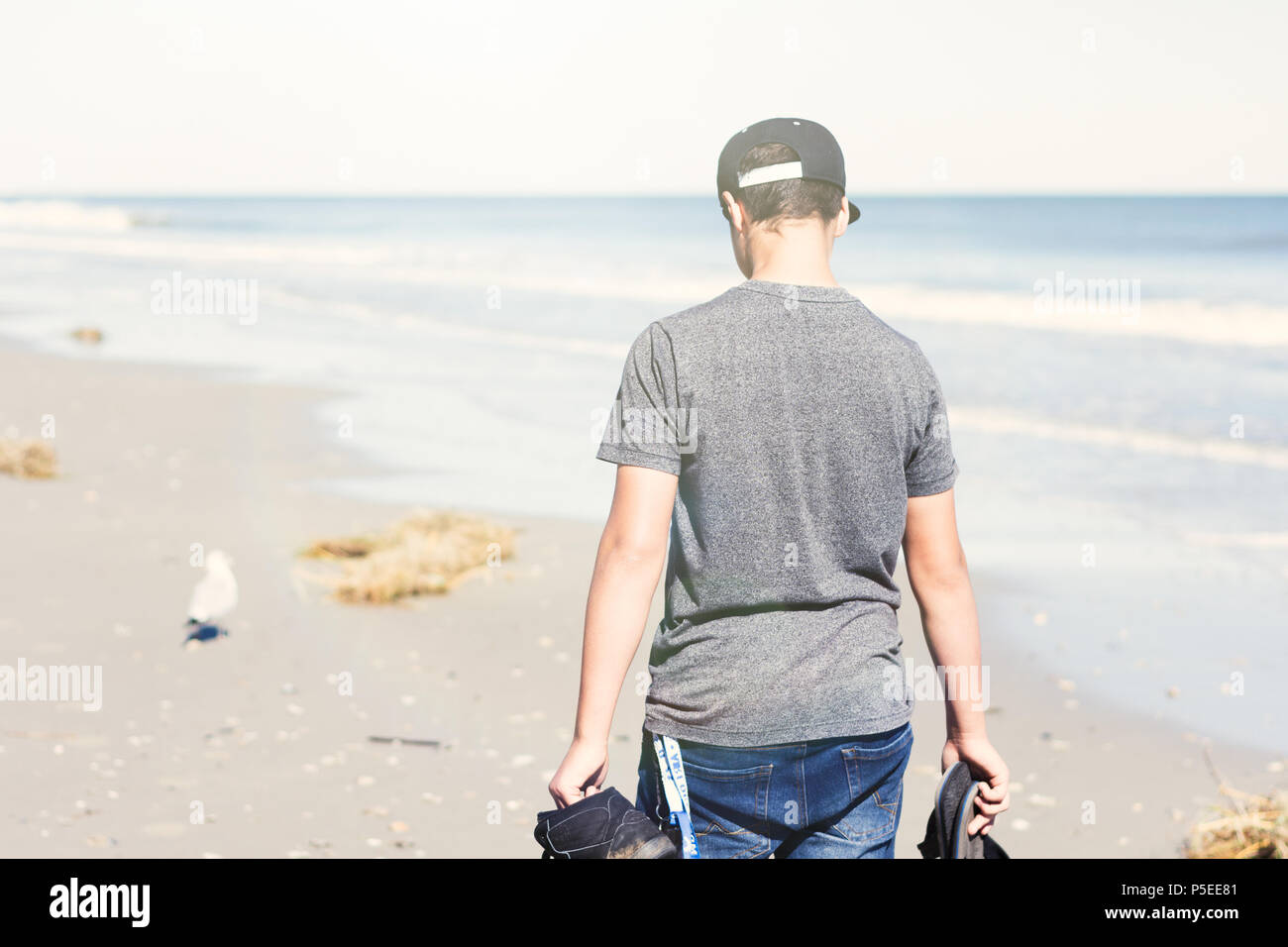 Teen walking on the beach in the spring Stock Photo - Alamy