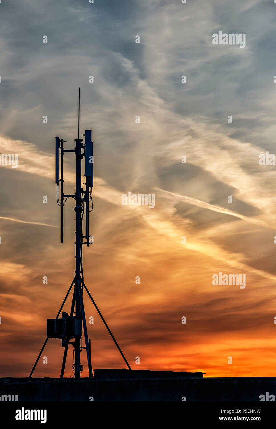 silhouette of GSM transmitters on the roof office building at amazing ...