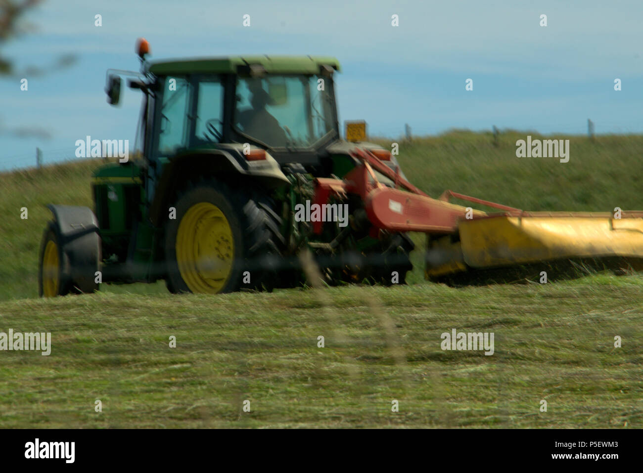 Tractor cutting silage Stock Photo - Alamy