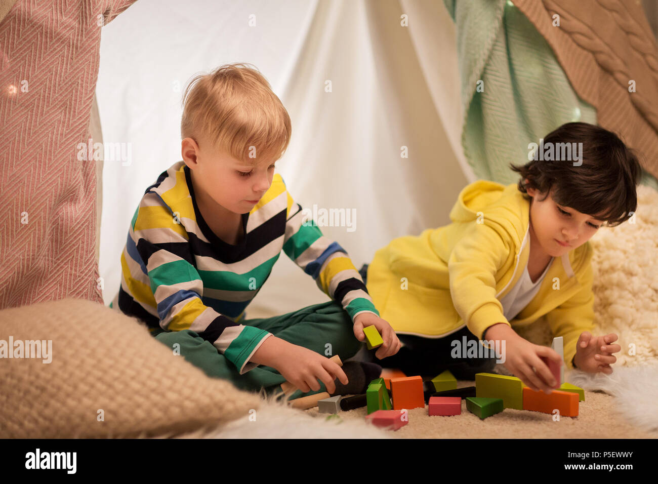 Adorable kids playing together blocks hi-res stock photography and ...