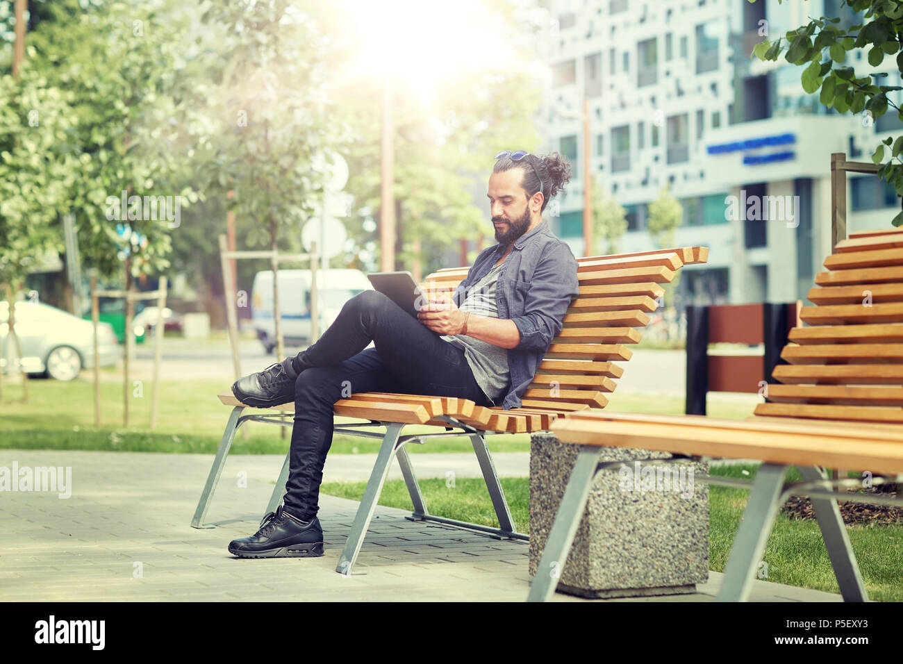 Person sitting on street bench city hi-res stock photography and images ...