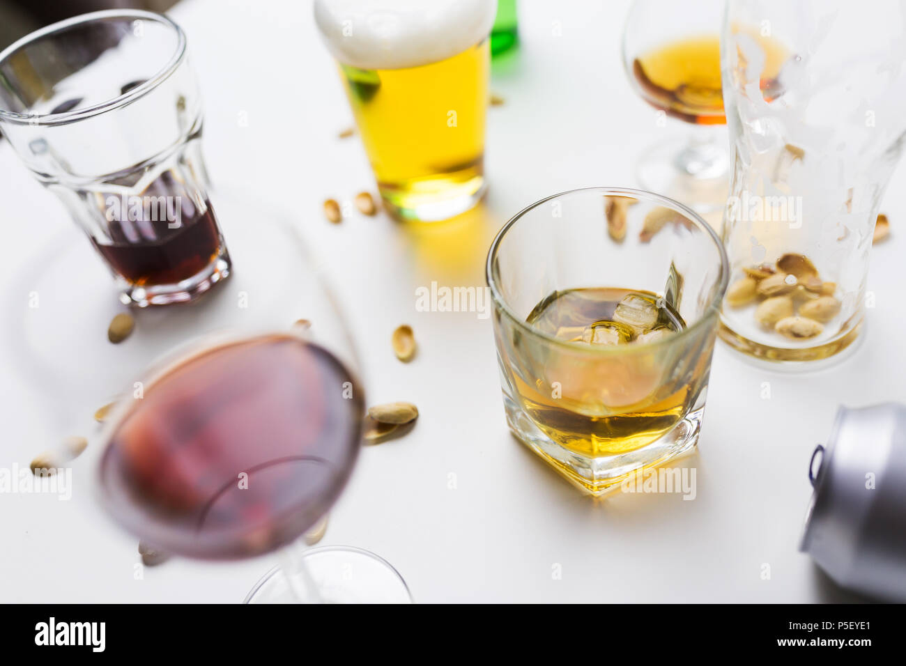 glasses of different alcohol drinks on messy table Stock Photo - Alamy