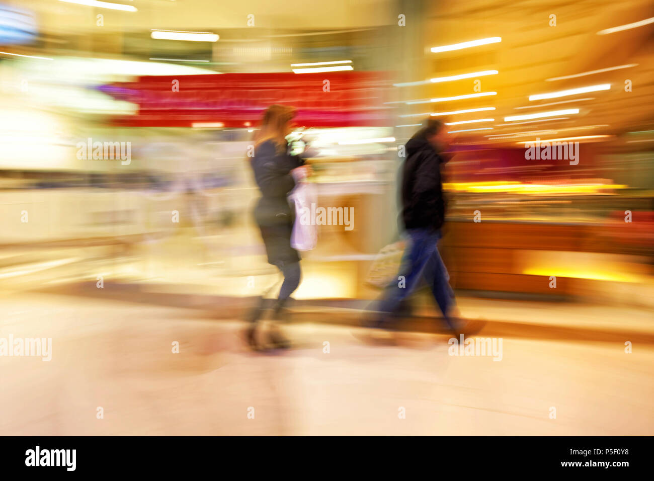 A shopper walking against shop window Stock Photo - Alamy