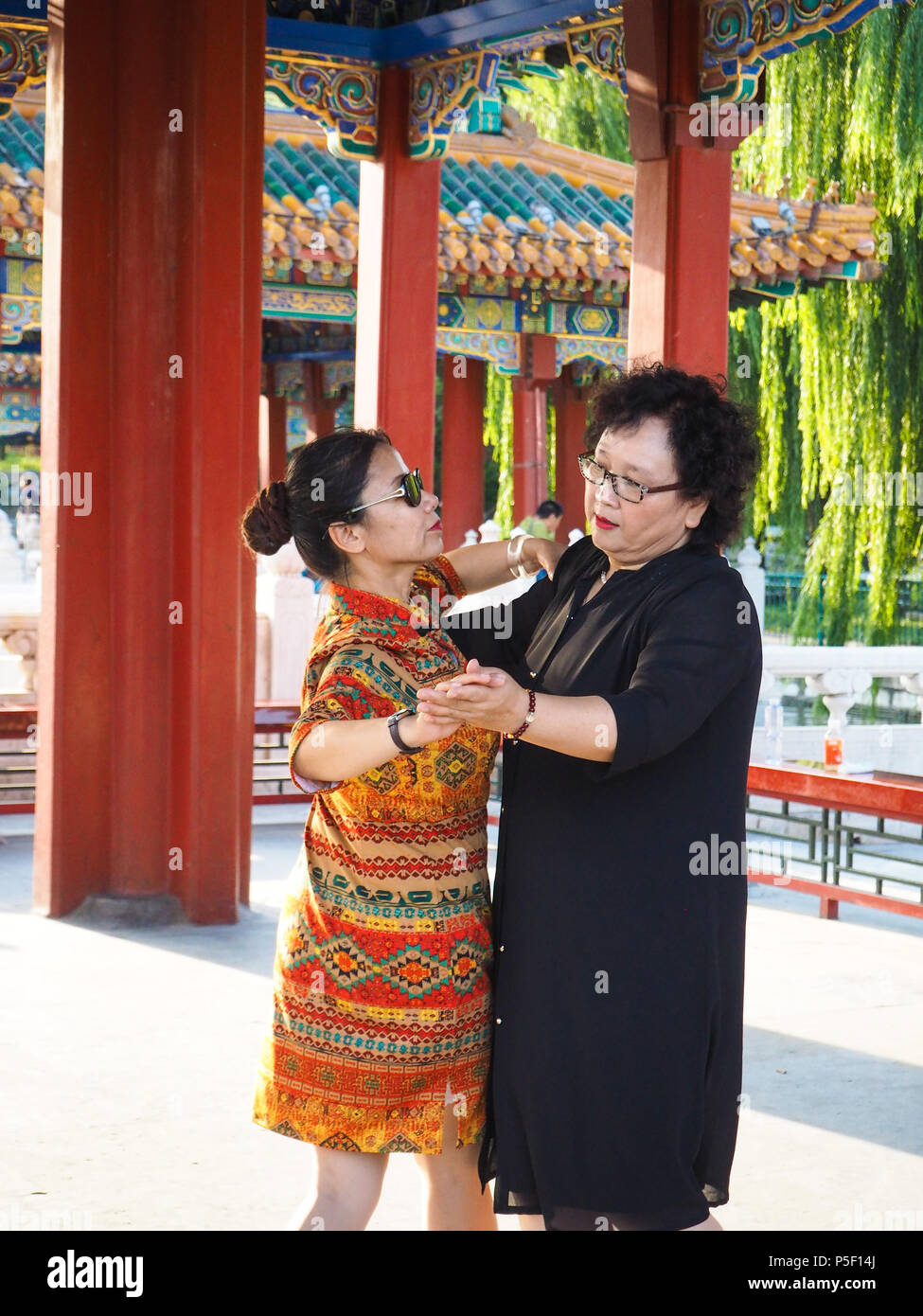 Beijing, China - September 2017: Two elder women dancing as a couple in ...