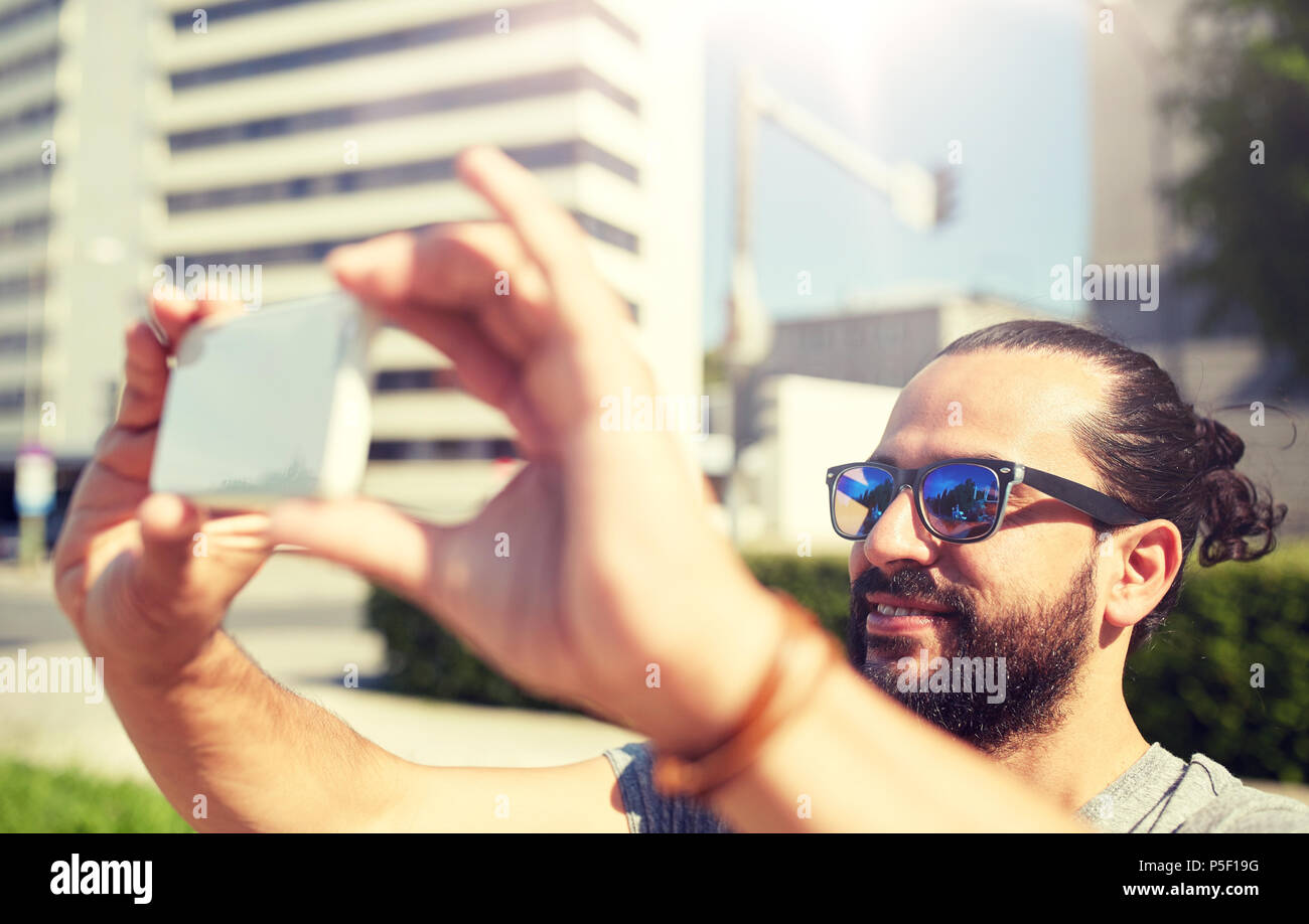 man taking video or selfie by smartphone in city Stock Photo - Alamy