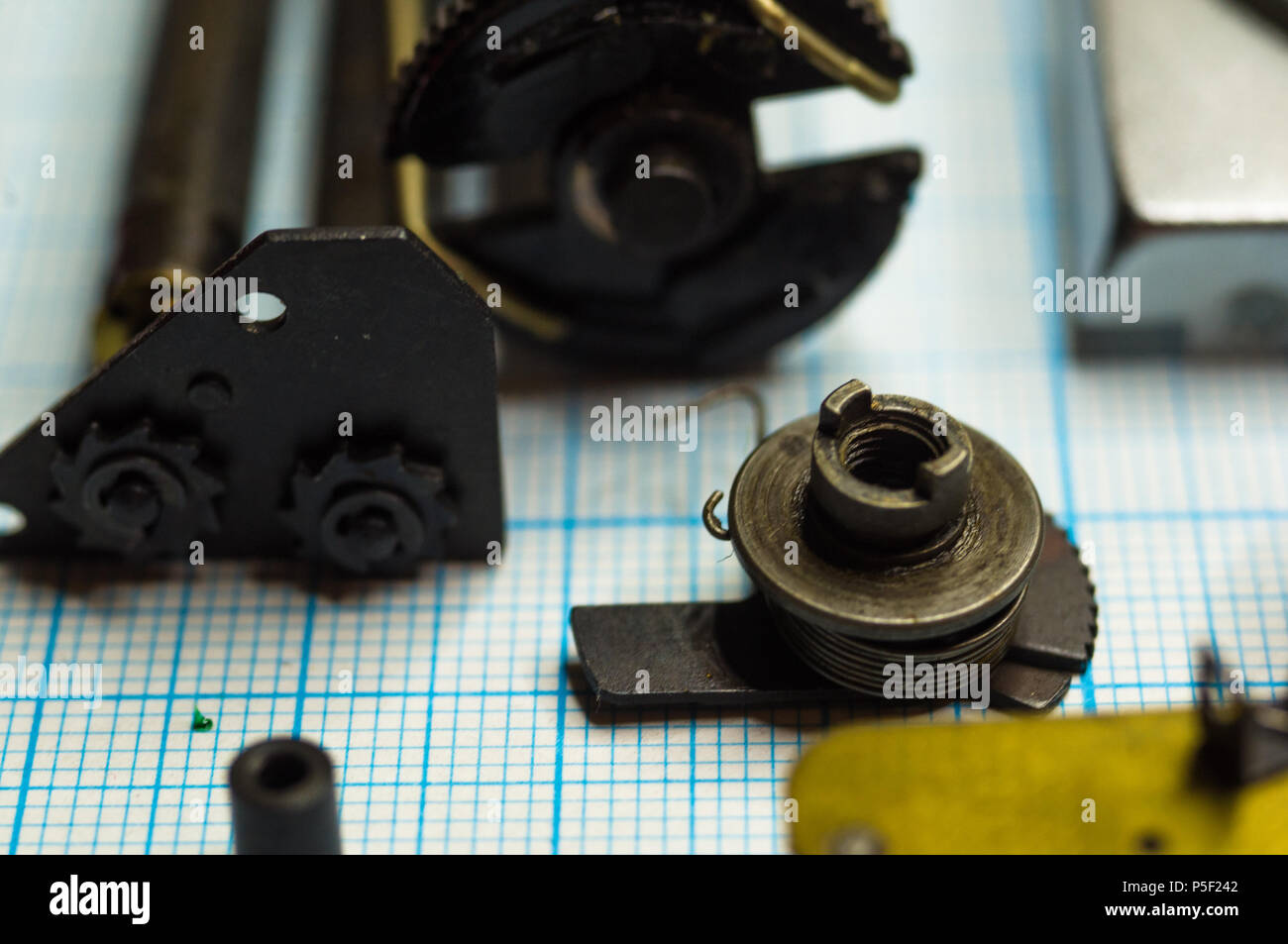 parts are completely disassembled old retro film SLR camera on graph ...