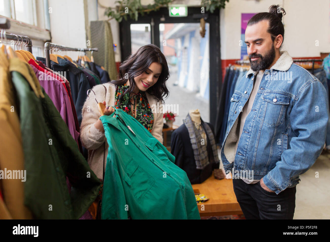 couple choosing clothes at vintage clothing store Stock Photo - Alamy