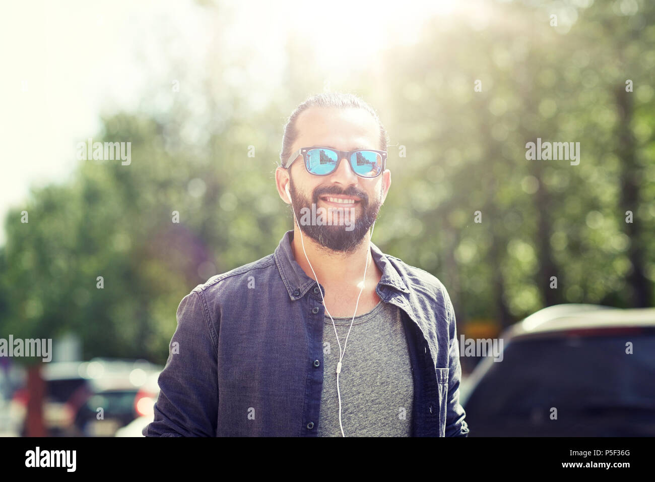 Young man walking listening music hi-res stock photography and images ...