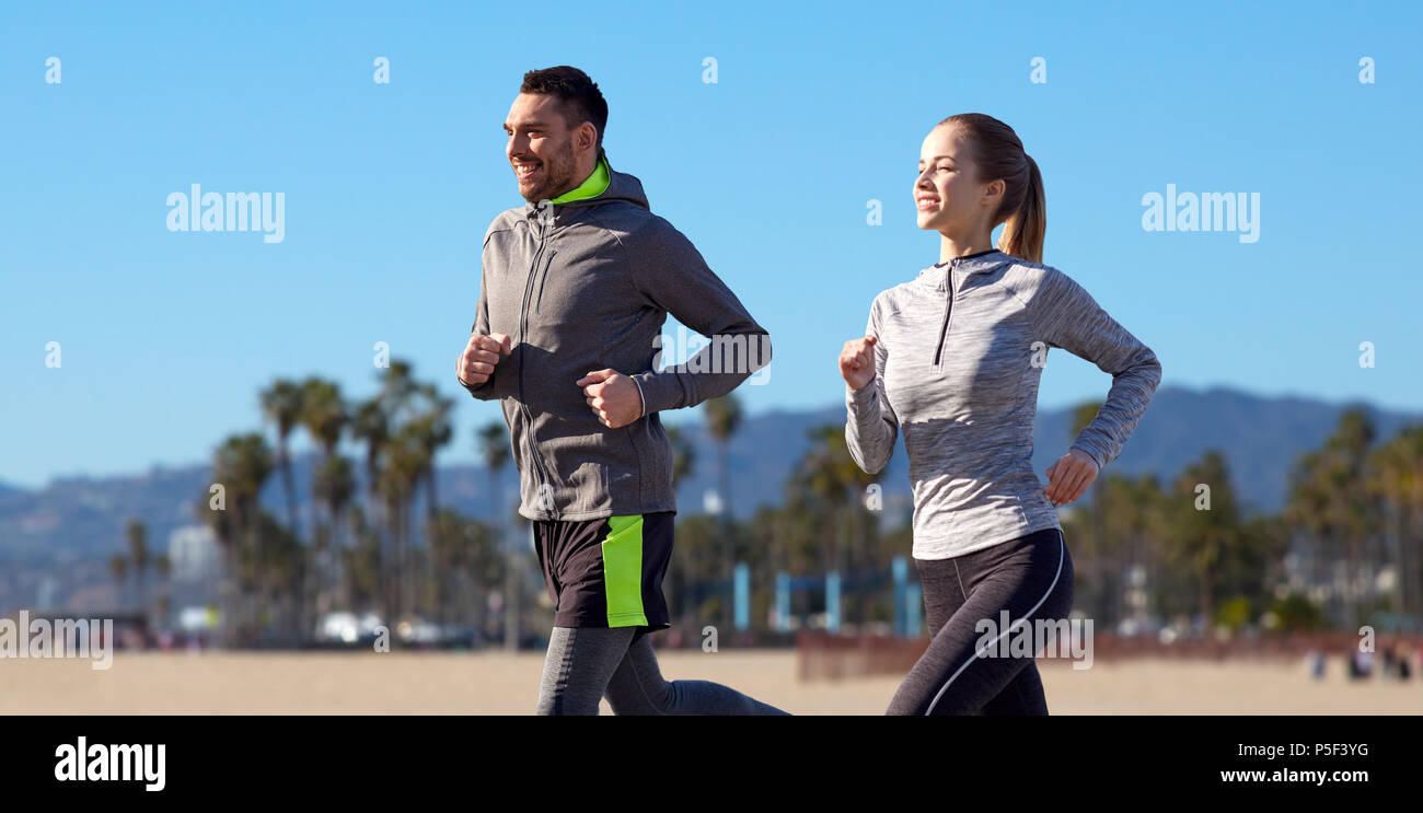 happy couple running outdoors Stock Photo - Alamy