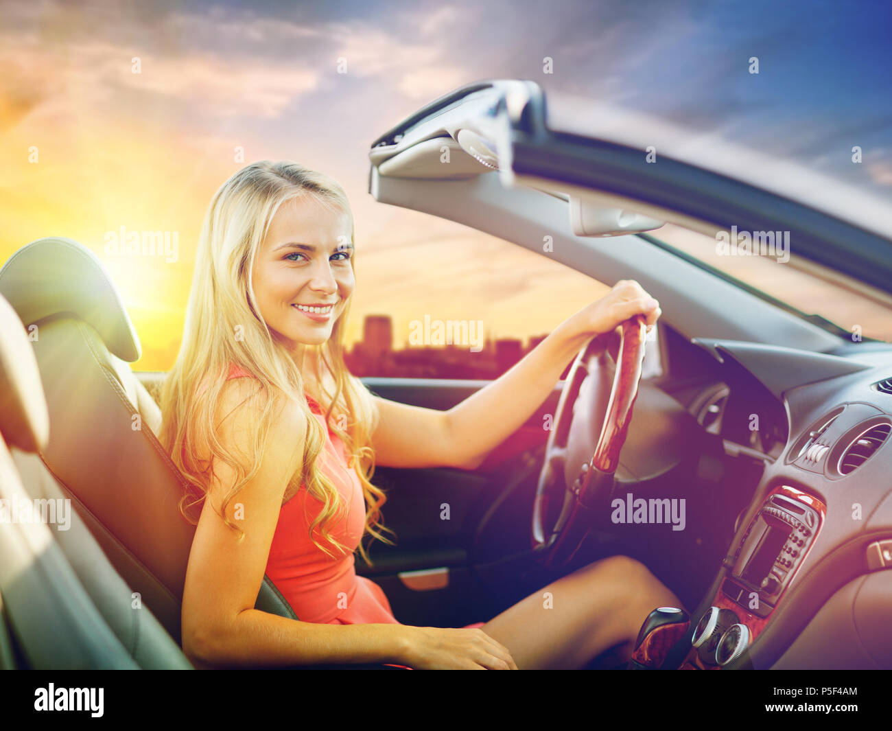 happy young woman driving convertible car Stock Photo - Alamy