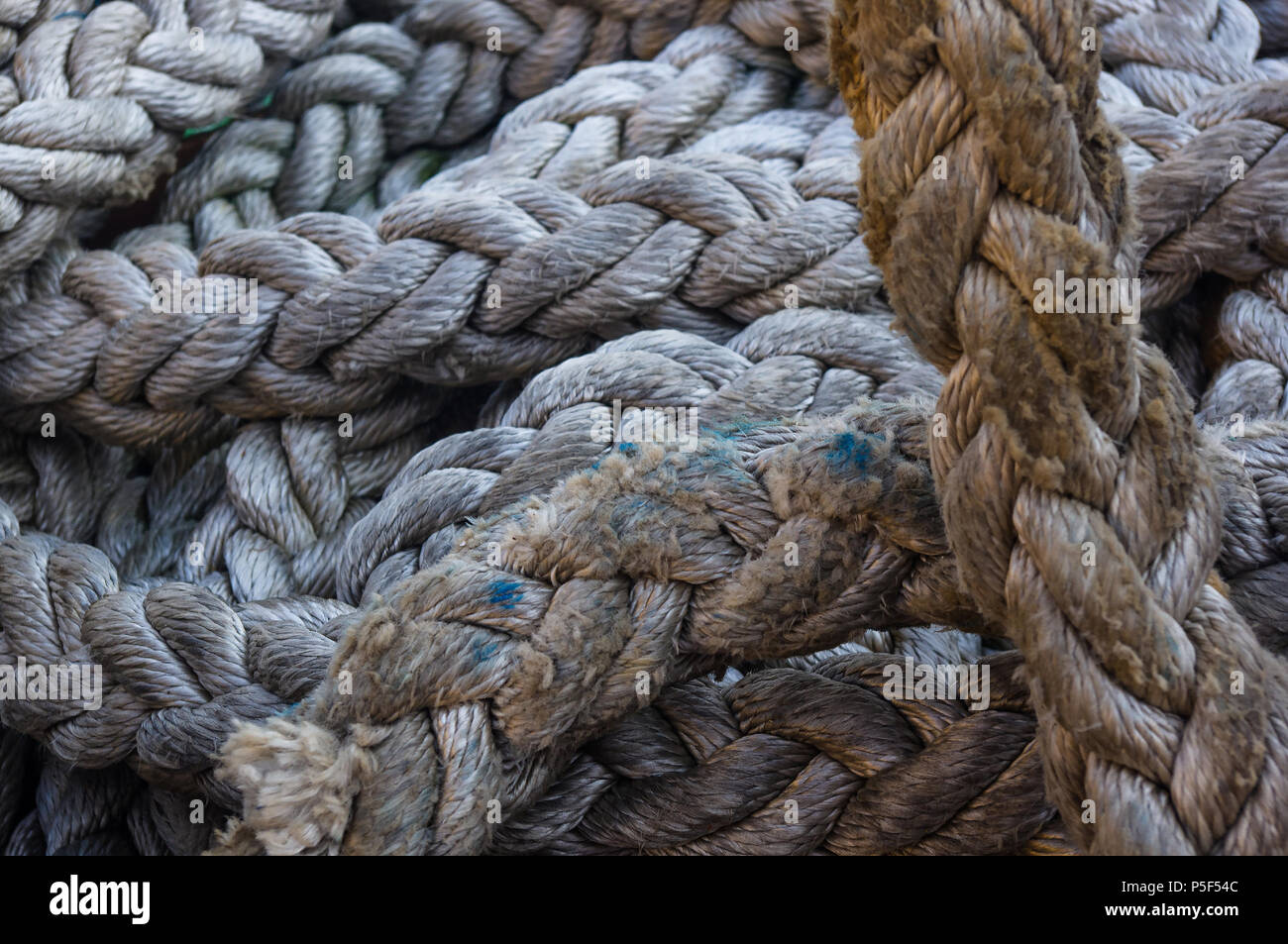 Old braided rope on the wooden deck of a sea boat, cleats, anchor ...