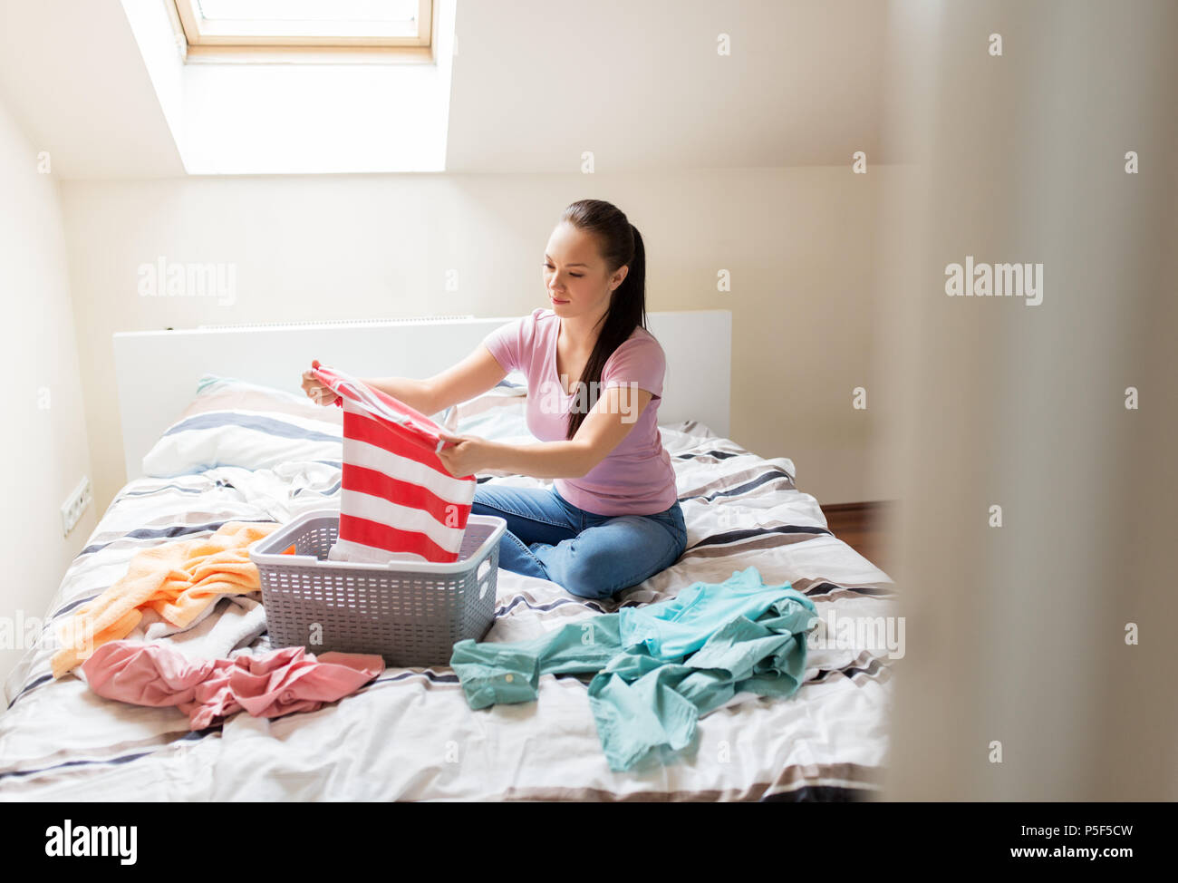 Woman sorting laundry hi-res stock photography and images - Alamy