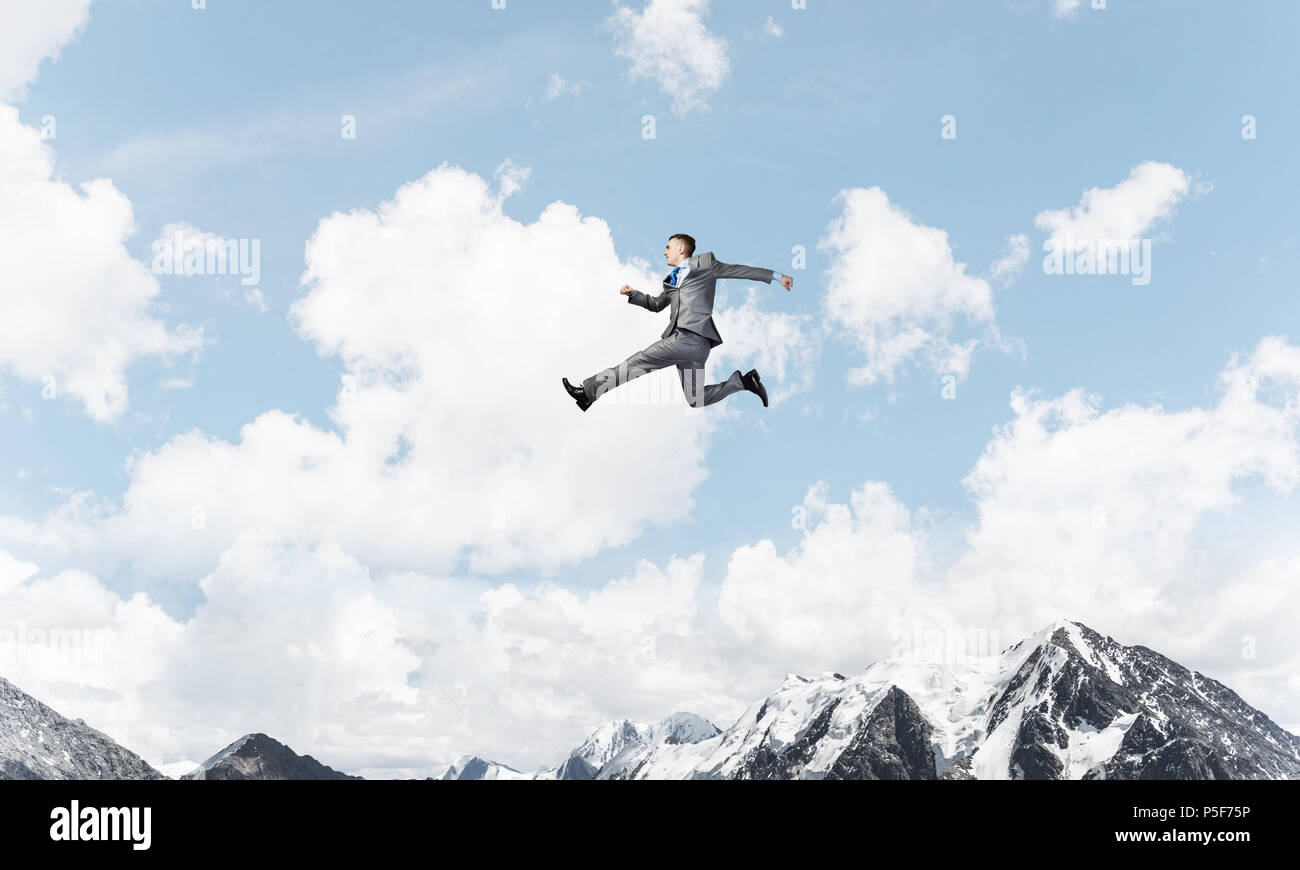 Businessman in suit running in the air as symbol of active life ...