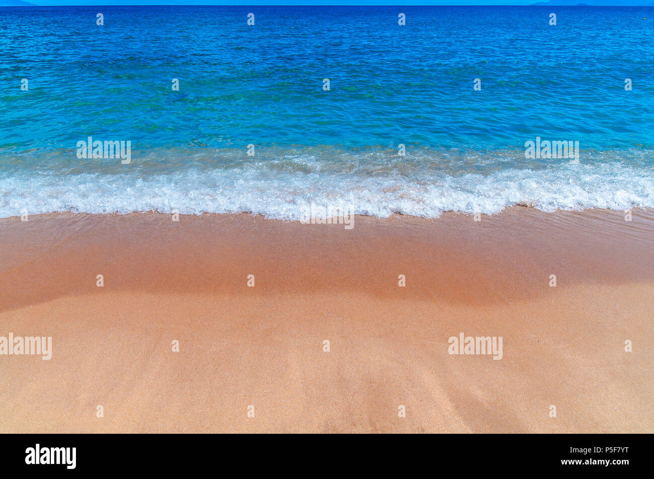 Blue ocean background with sandy beach Stock Photo - Alamy