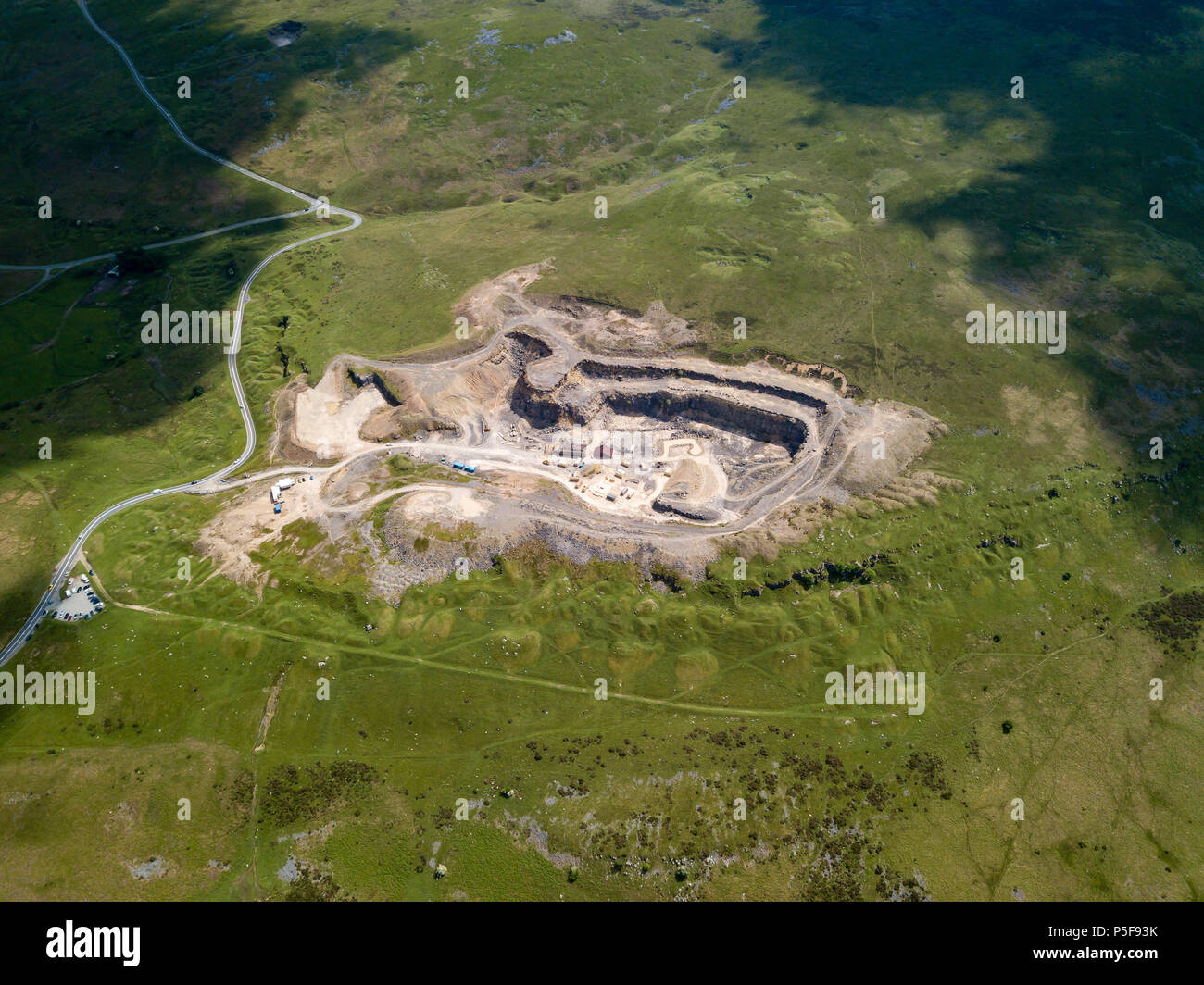 Aerial drone view of an old quarry scarring the otherwise green ...