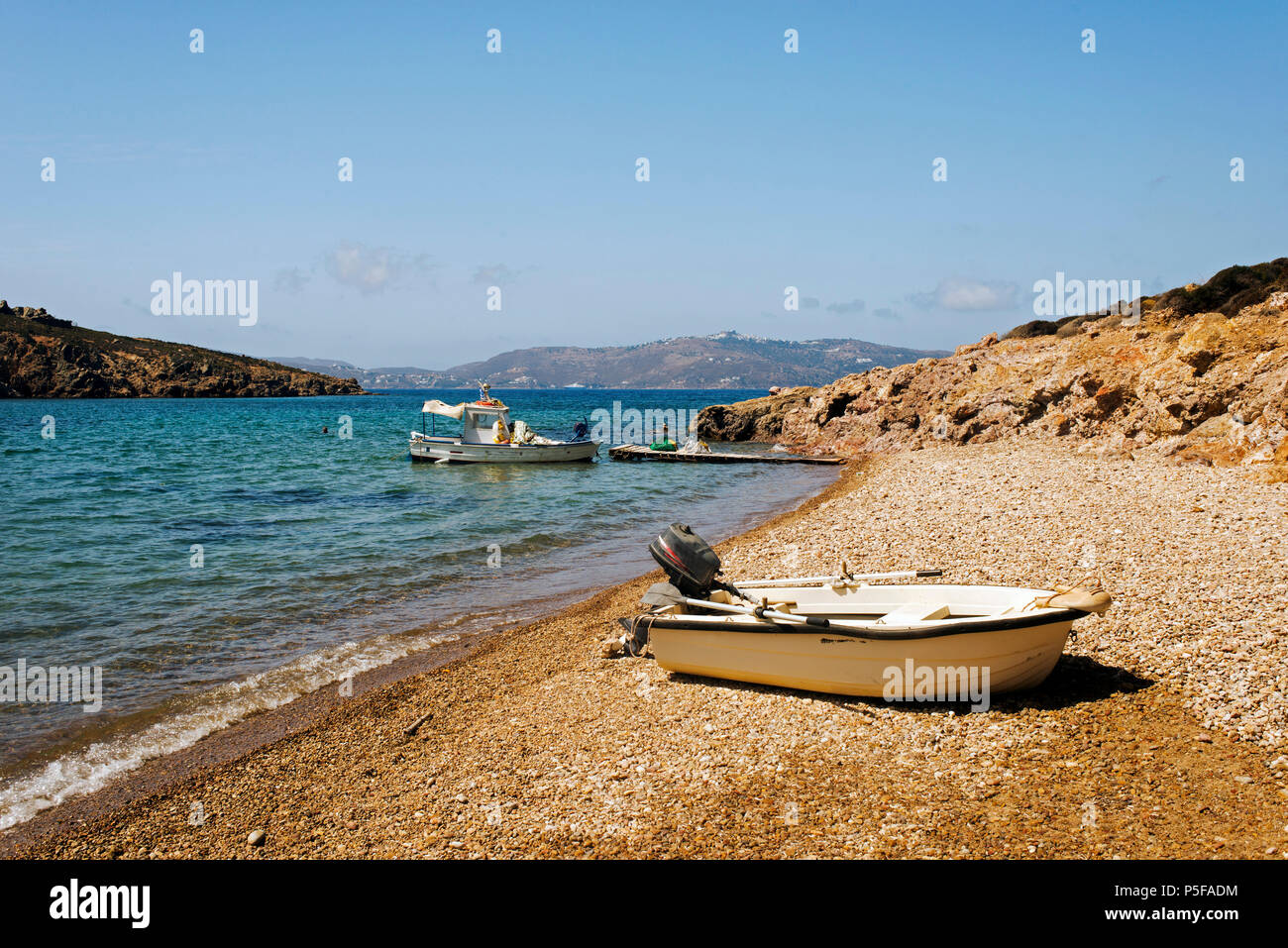 A view of a beach with fishing boats in the island of Patmos, Greece in ...