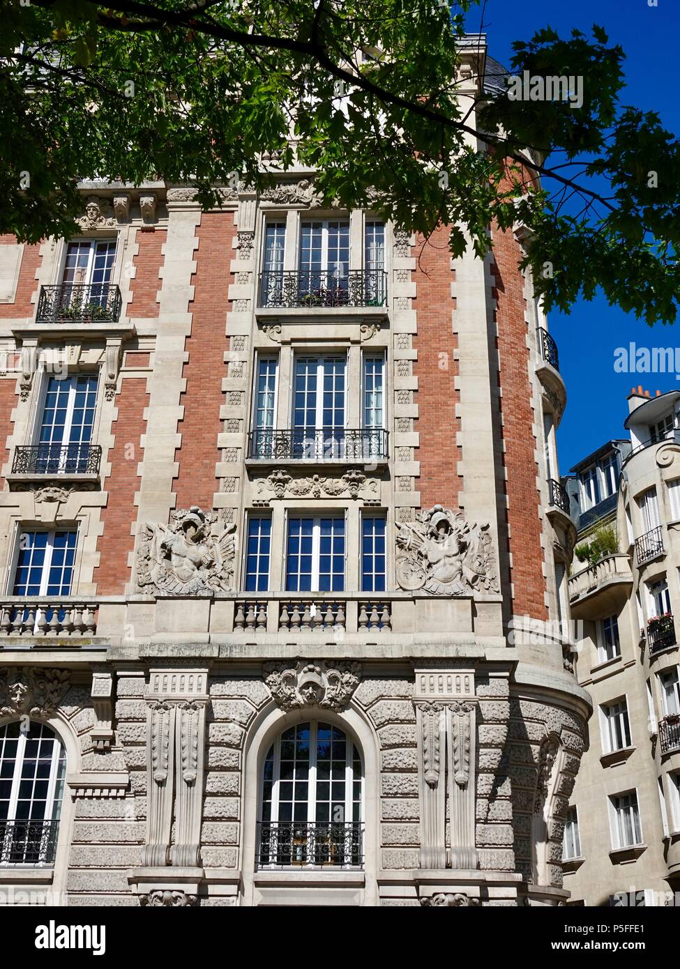 Front facade of red brick and limestone apartment building on rue ...