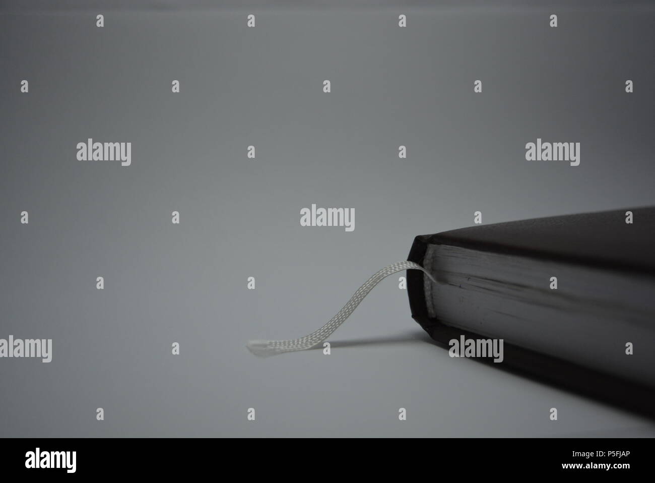 Brown, black small book, notebook with bookmark, diary arranged on ...