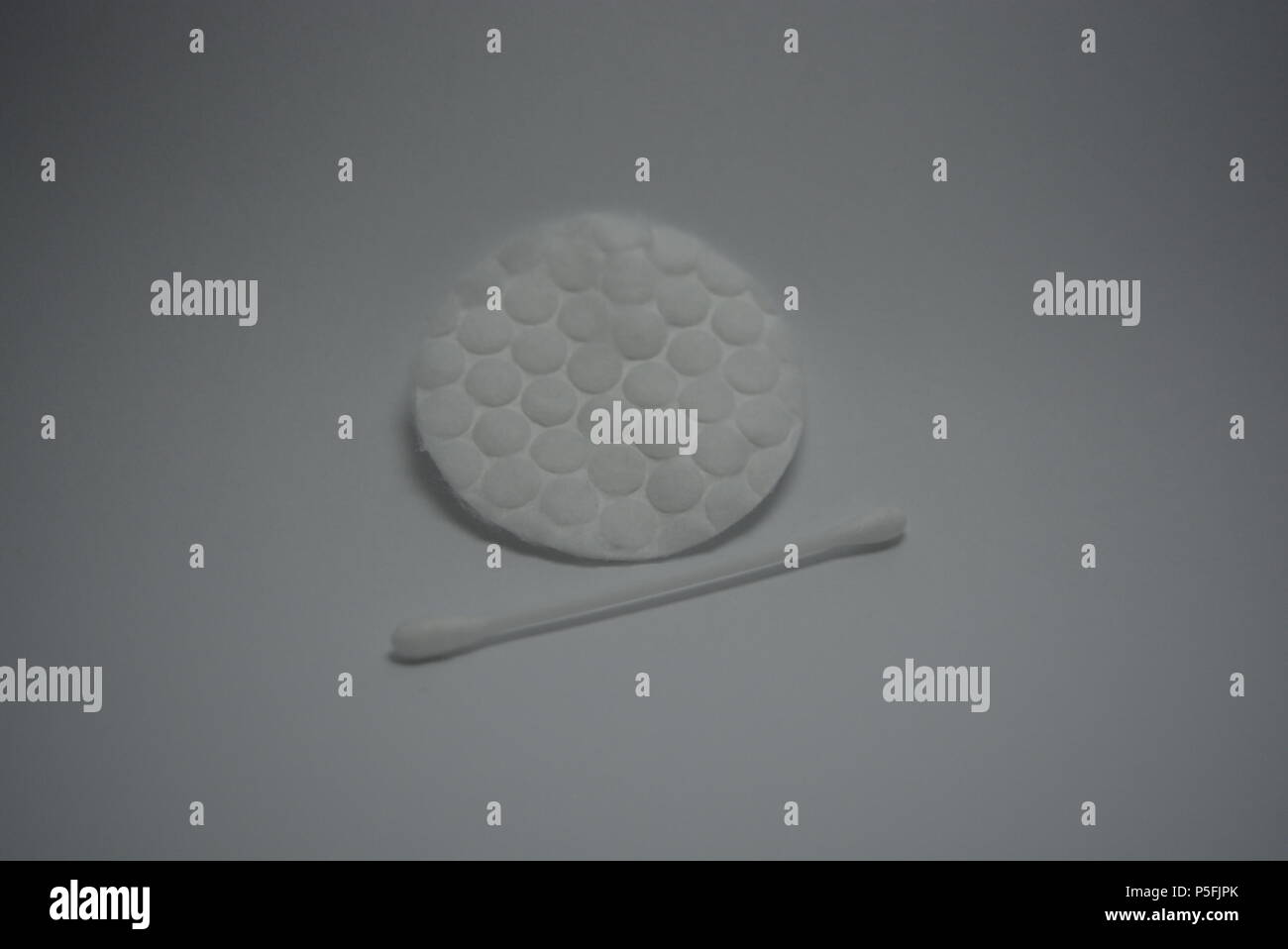 White cotton swabs and ear sticks are arranged on a white background ...