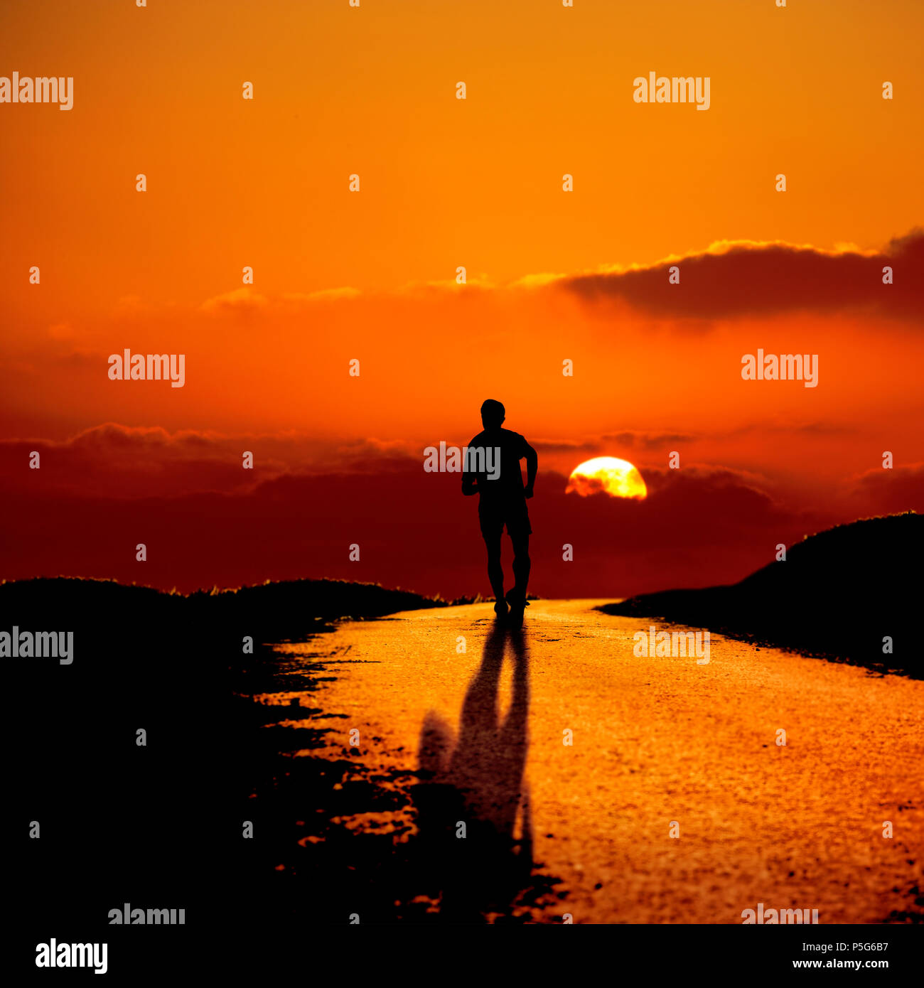 An image of a man running with beautiful sunset Stock Photo - Alamy