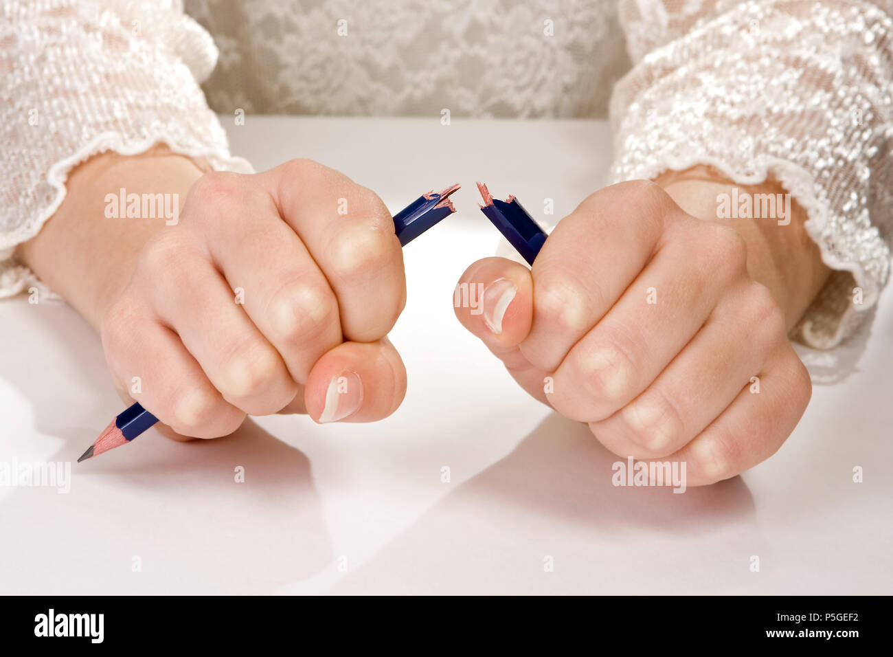 Hands of a woman in stress, breaking a pencil Stock Photo - Alamy