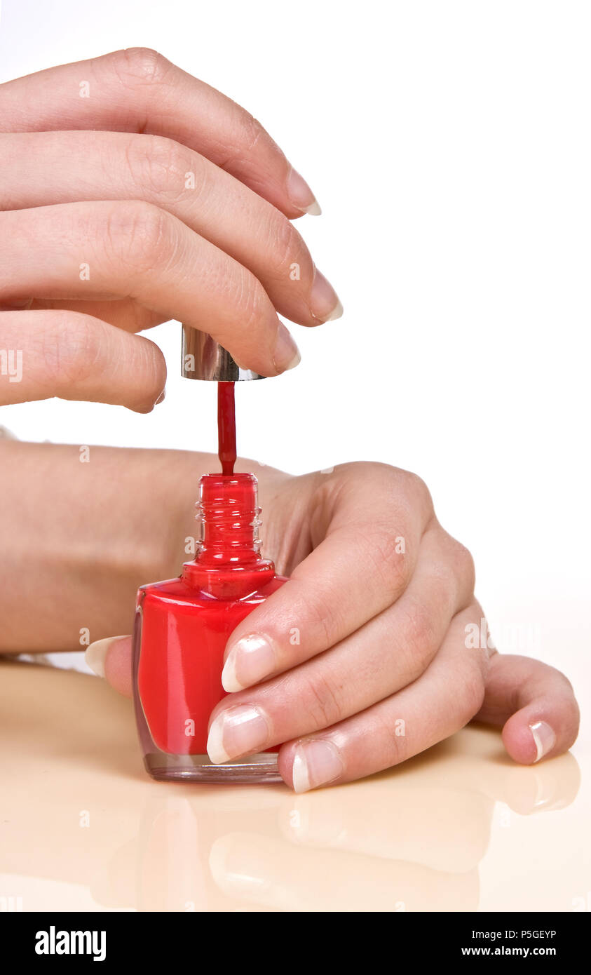 Female hands putting on flashy red nail polish Stock Photo - Alamy