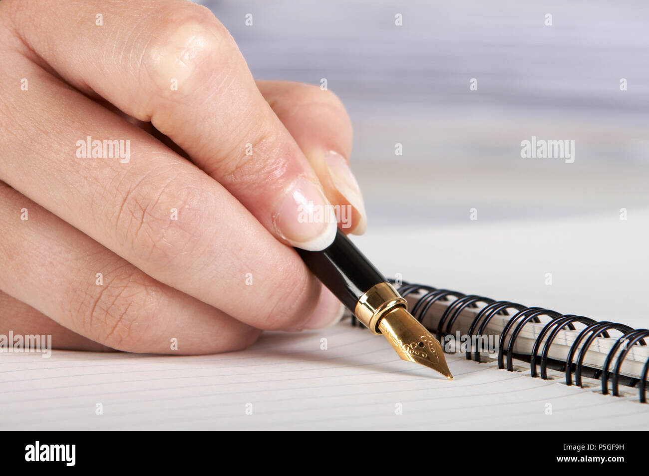 Well manicured hand writing with a golden fountain pen Stock Photo - Alamy