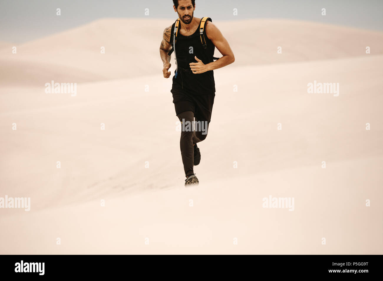 Athlete running on sand dunes hi-res stock photography and images - Alamy