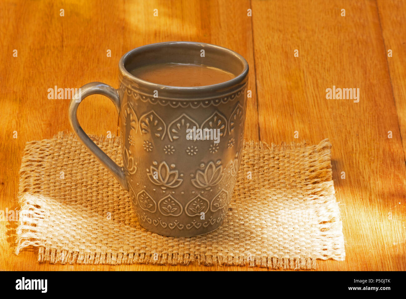 Coffee in a mug on wooden table Stock Photo - Alamy