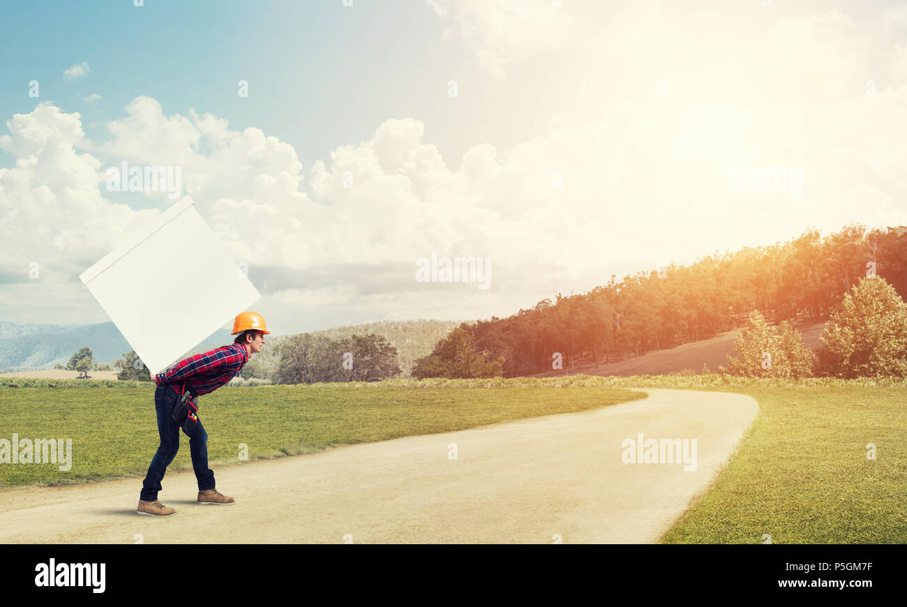 Man carrying on his back large box Stock Photo - Alamy
