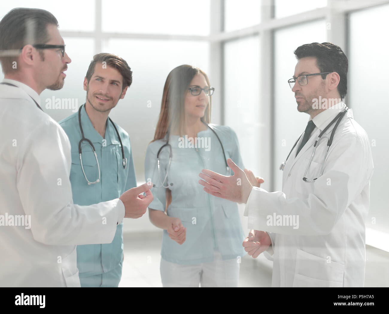 group of doctors discussing problems in the hospital corridor Stock ...